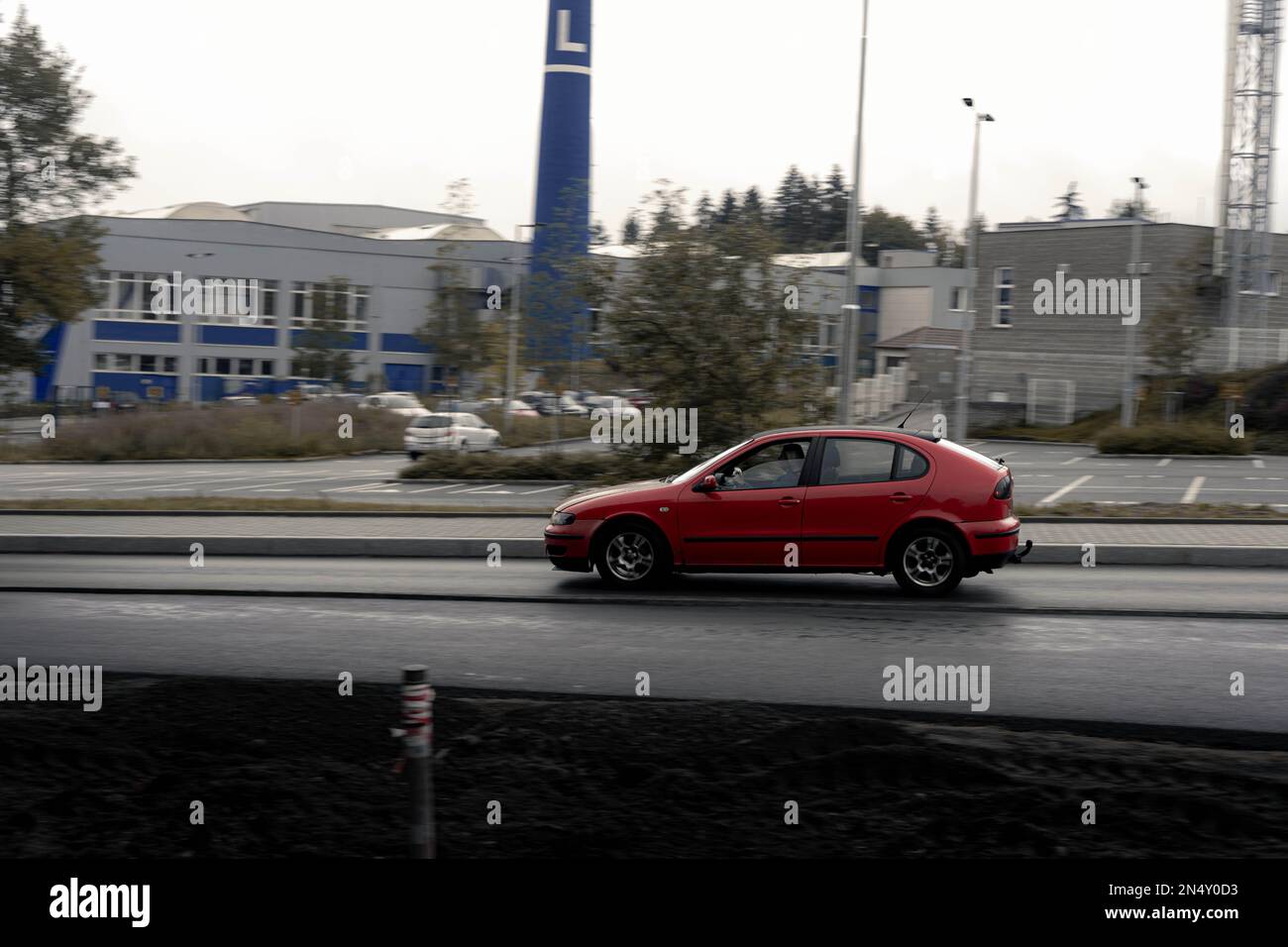 A Red Suzuki car driving on the street in Jablonec nad Niso city, Czech ...
