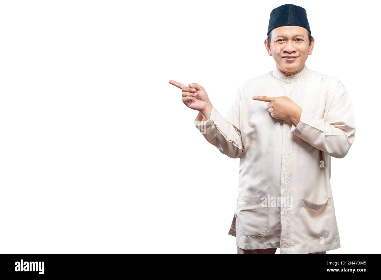 Asian Muslim man pointing something isolated over white background ...