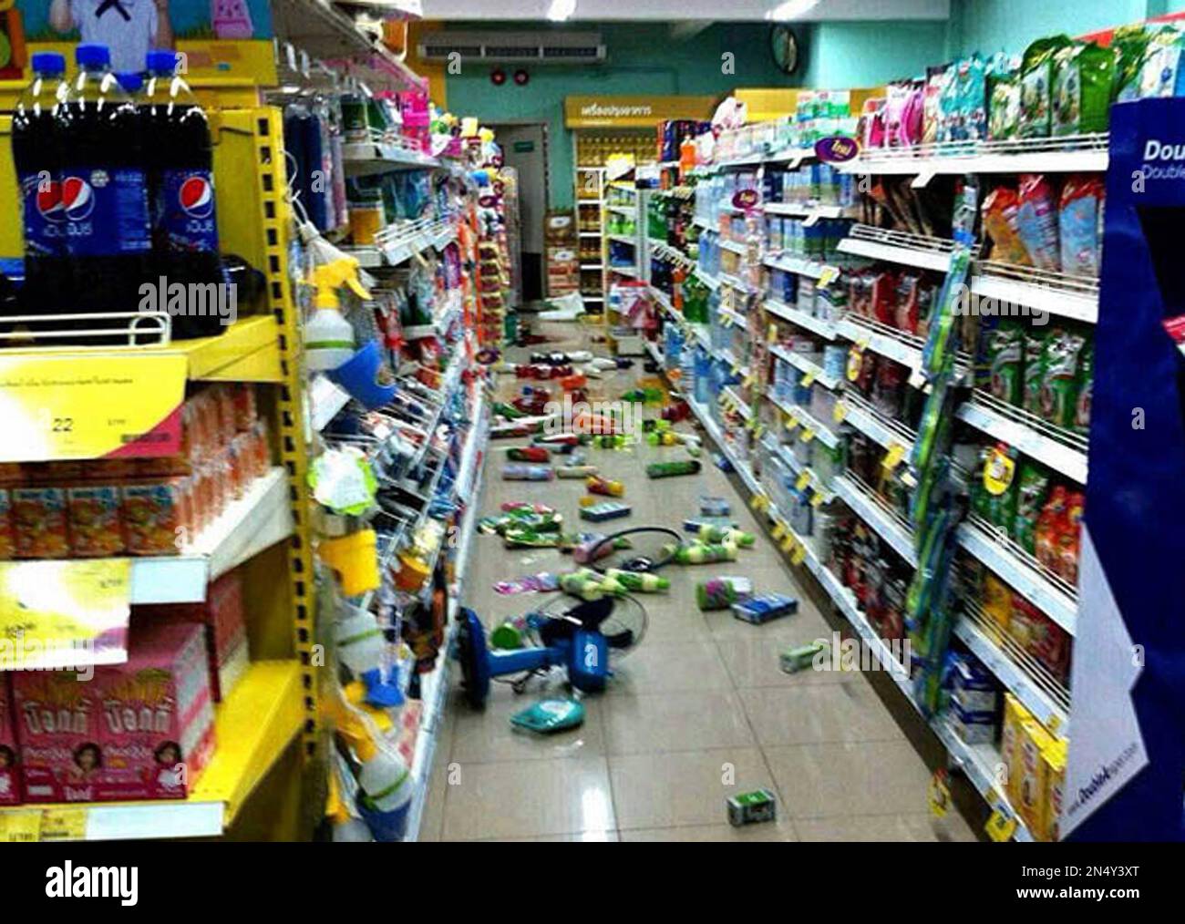 Goods at a grocery store fallen from from the shelves after an ...
