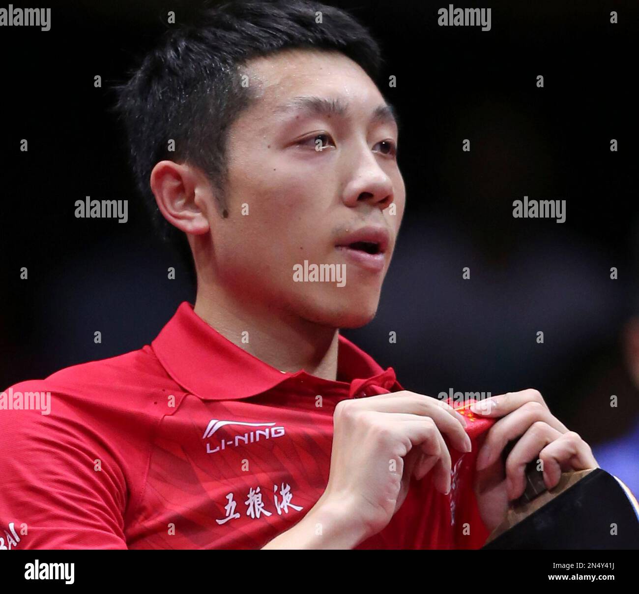 Xu Xin of China shows a national fag of China on his uniform after ...