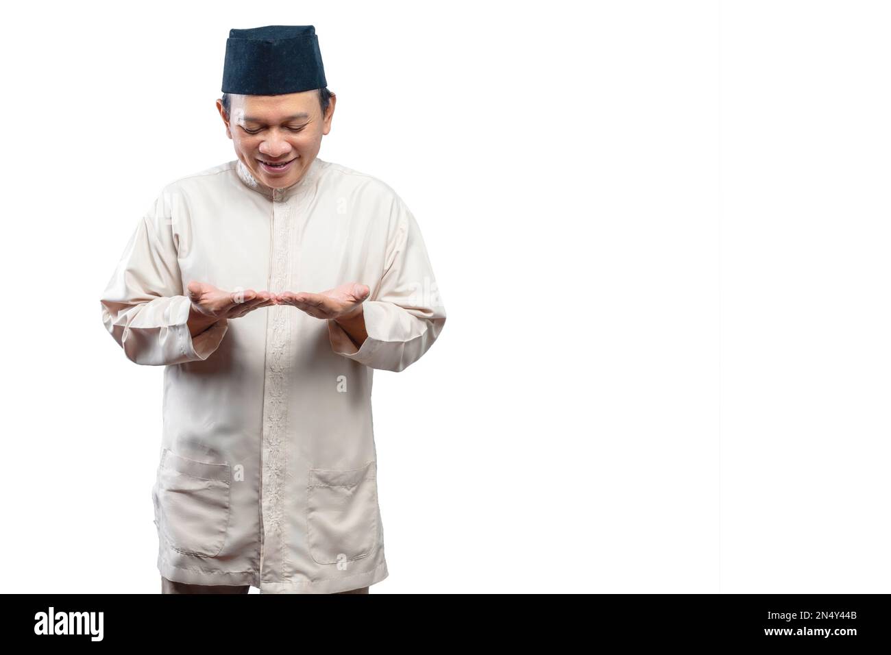 Asian Muslim man with open palm hand showing something isolated over ...