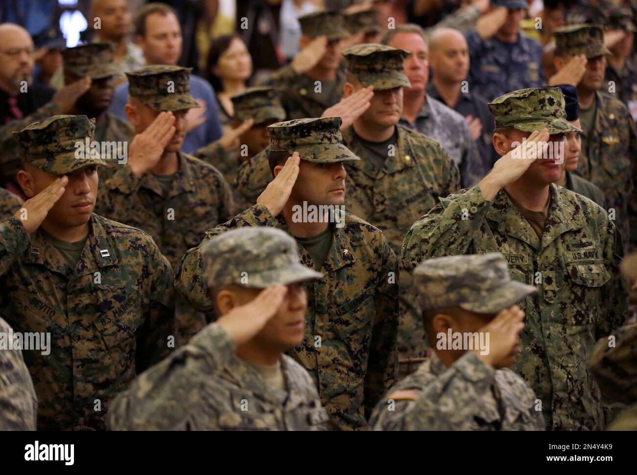 U.S. and Philippine military officers salute during the opening ...