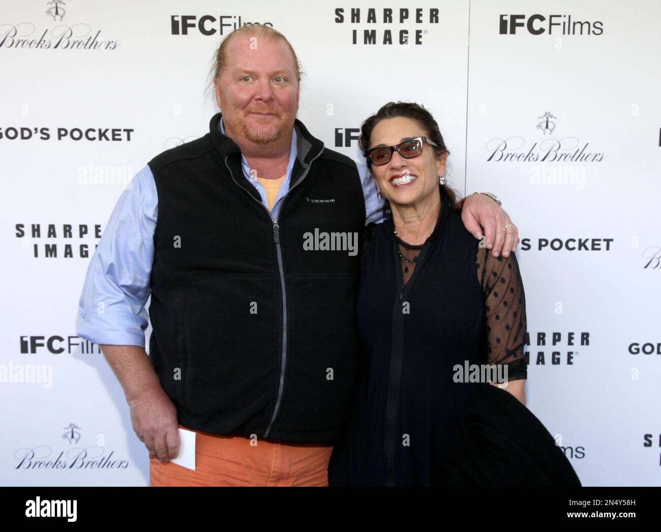 Restauranteur Mario Batali, left, and his wife Susi Cahn, right, attend ...
