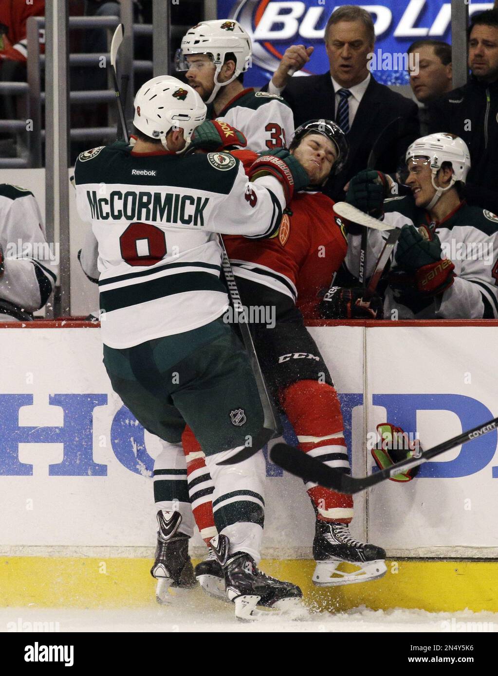 Chicago Blackhawks' Jeremy Morin (11) is hit by Minnesota Wild's Cody ...