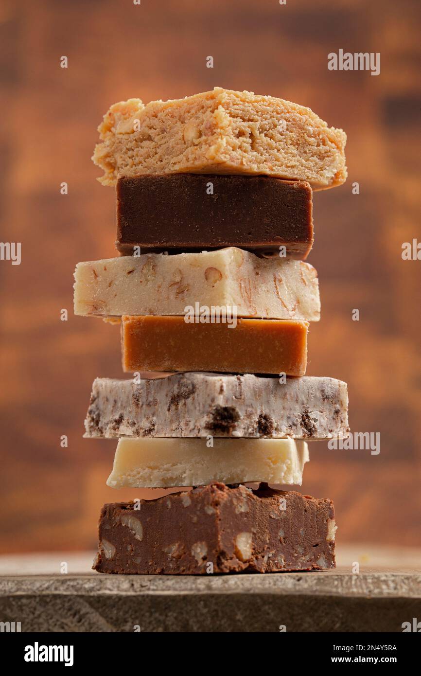 A Stack of Six Different Types of Fudge with a Butcherblock Background ...