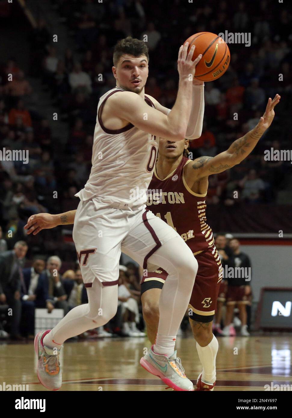Virginia Tech's Hunter Cattoor (0) drives to the basket past Boston ...