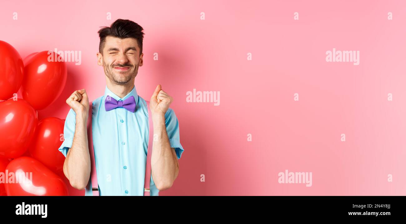 Valentines day concept. Cheerful guy jumping from excitement before ...