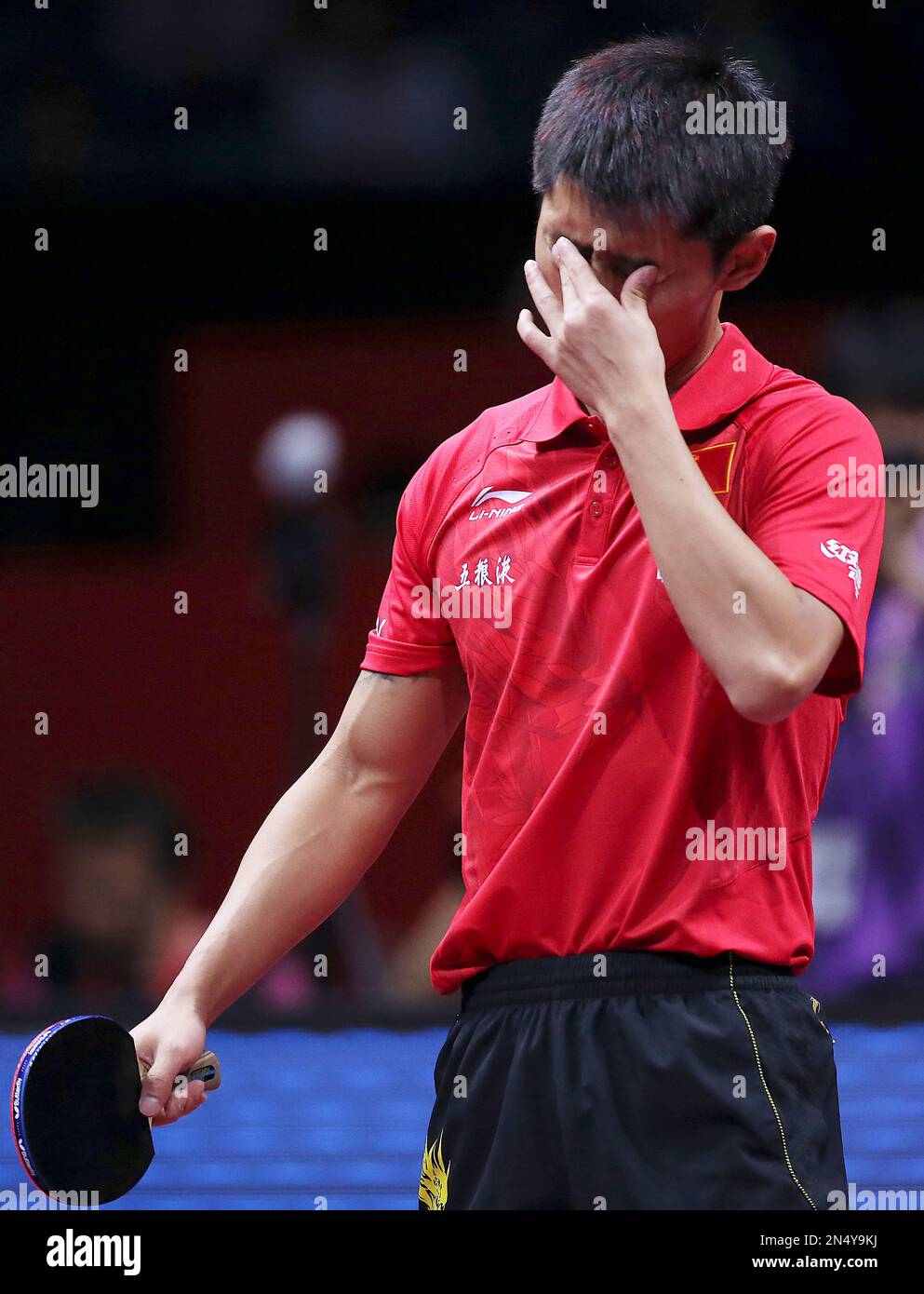 Zhang Jike of China reacts after loosing a point during his semifinal ...