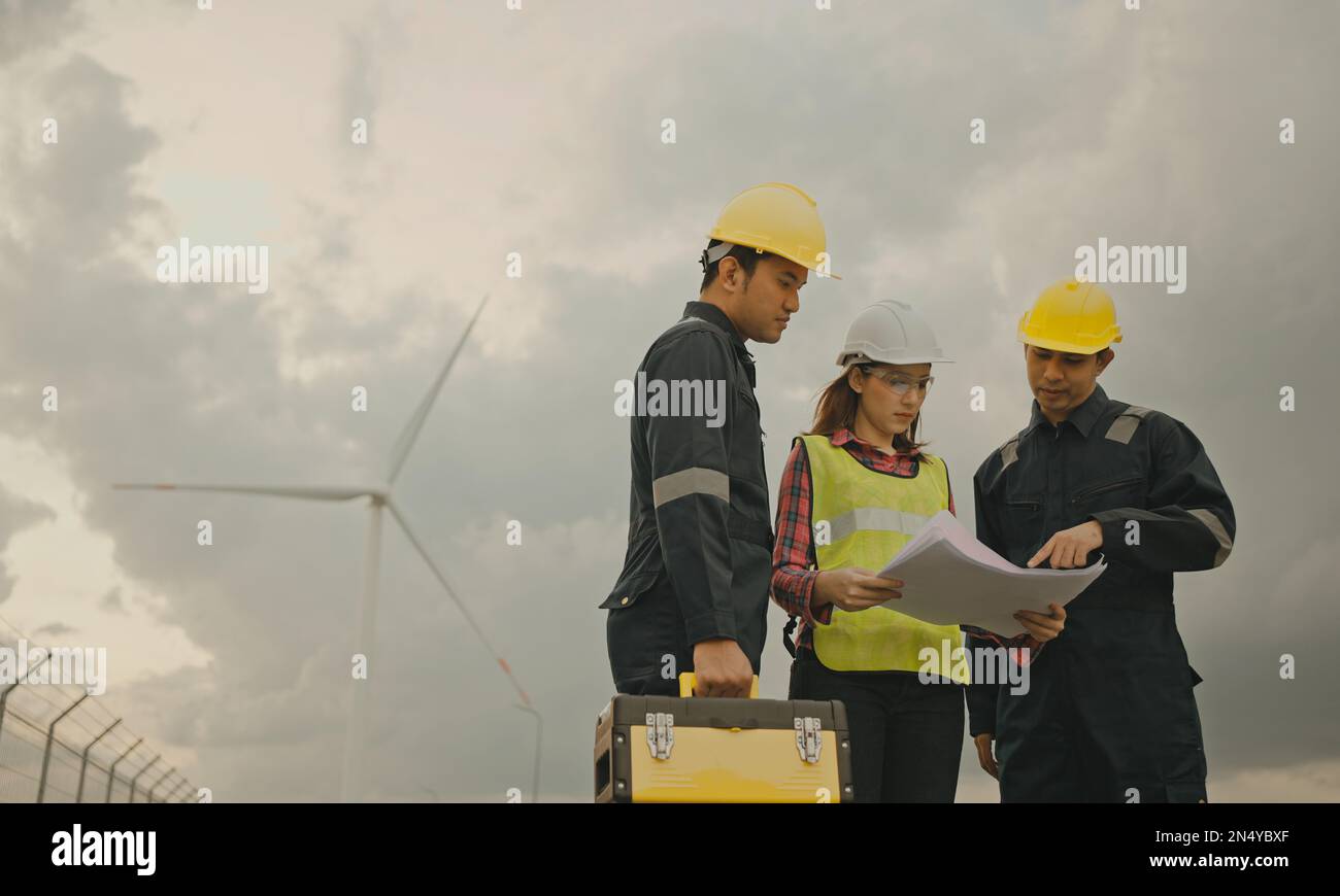 Three technician engineer in uniform with standing and checking wind ...