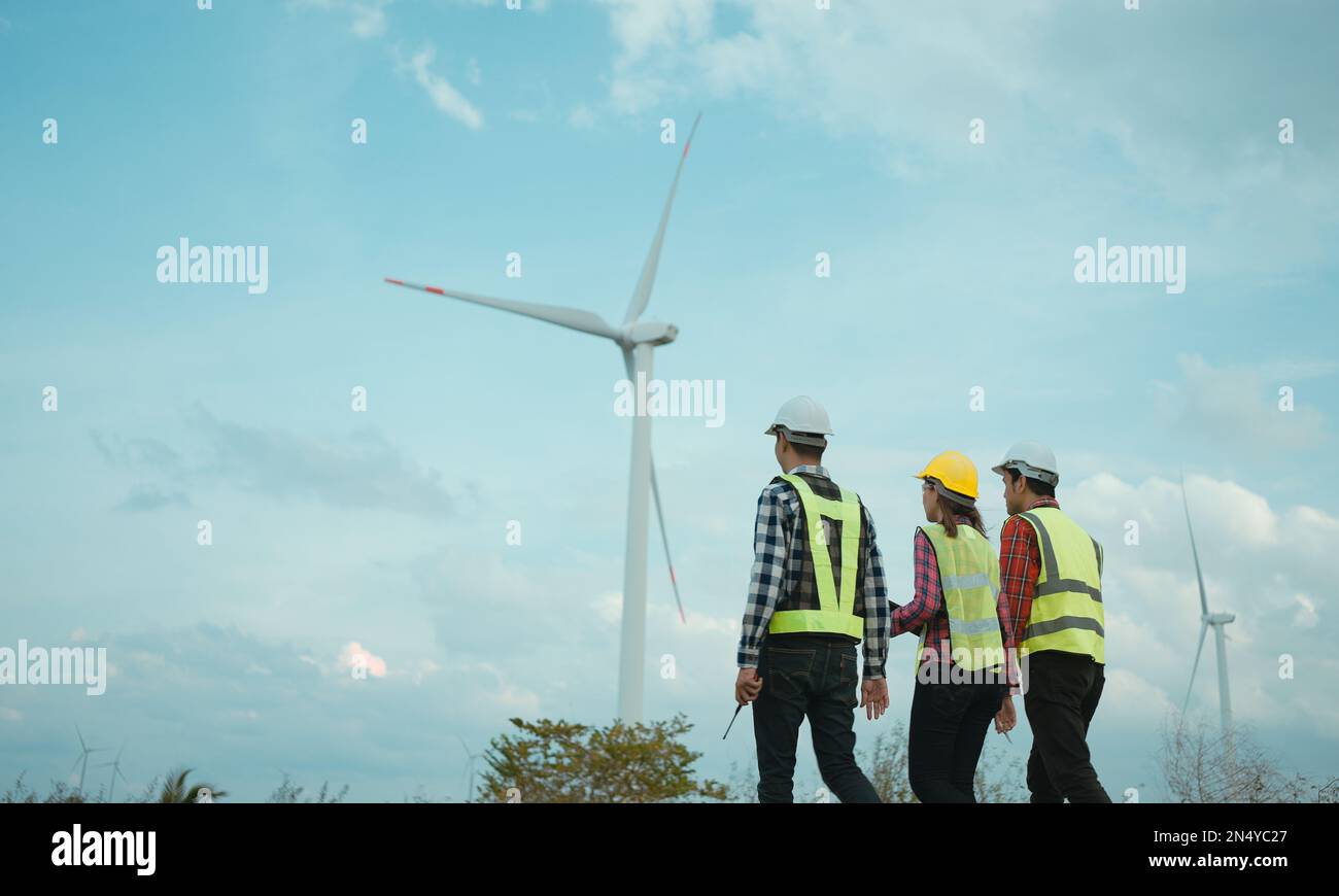 Back view of three engineers discussing and progress check wind turbine ...