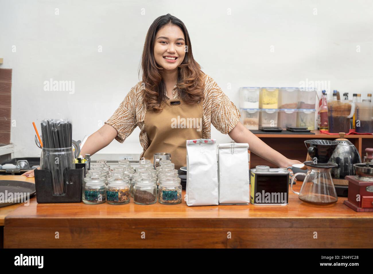 Asian woman baristas standing behind the counter in the cafe Stock ...
