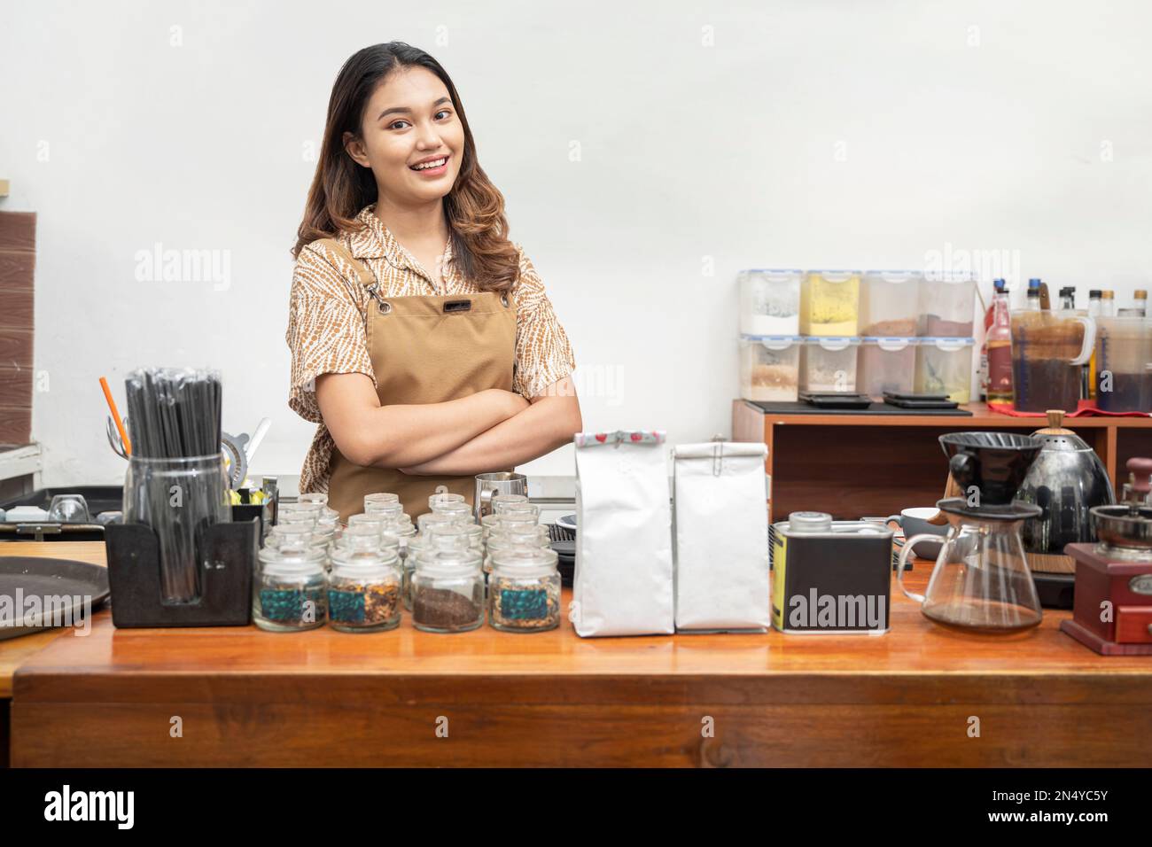 Asian woman baristas standing behind the counter in the cafe Stock Photo - Alamy