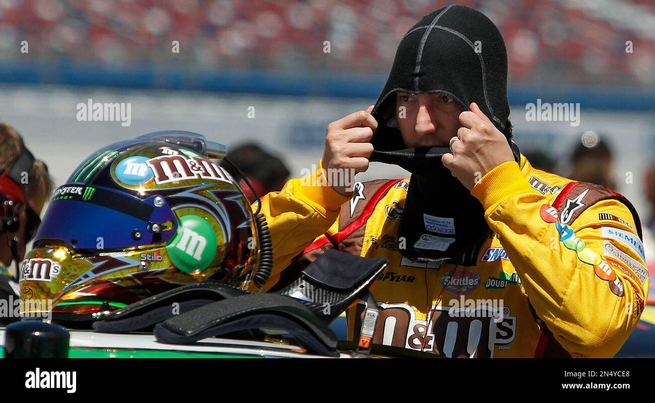Driver Kyle Busch prepares to enter his car before qualifying for the ...