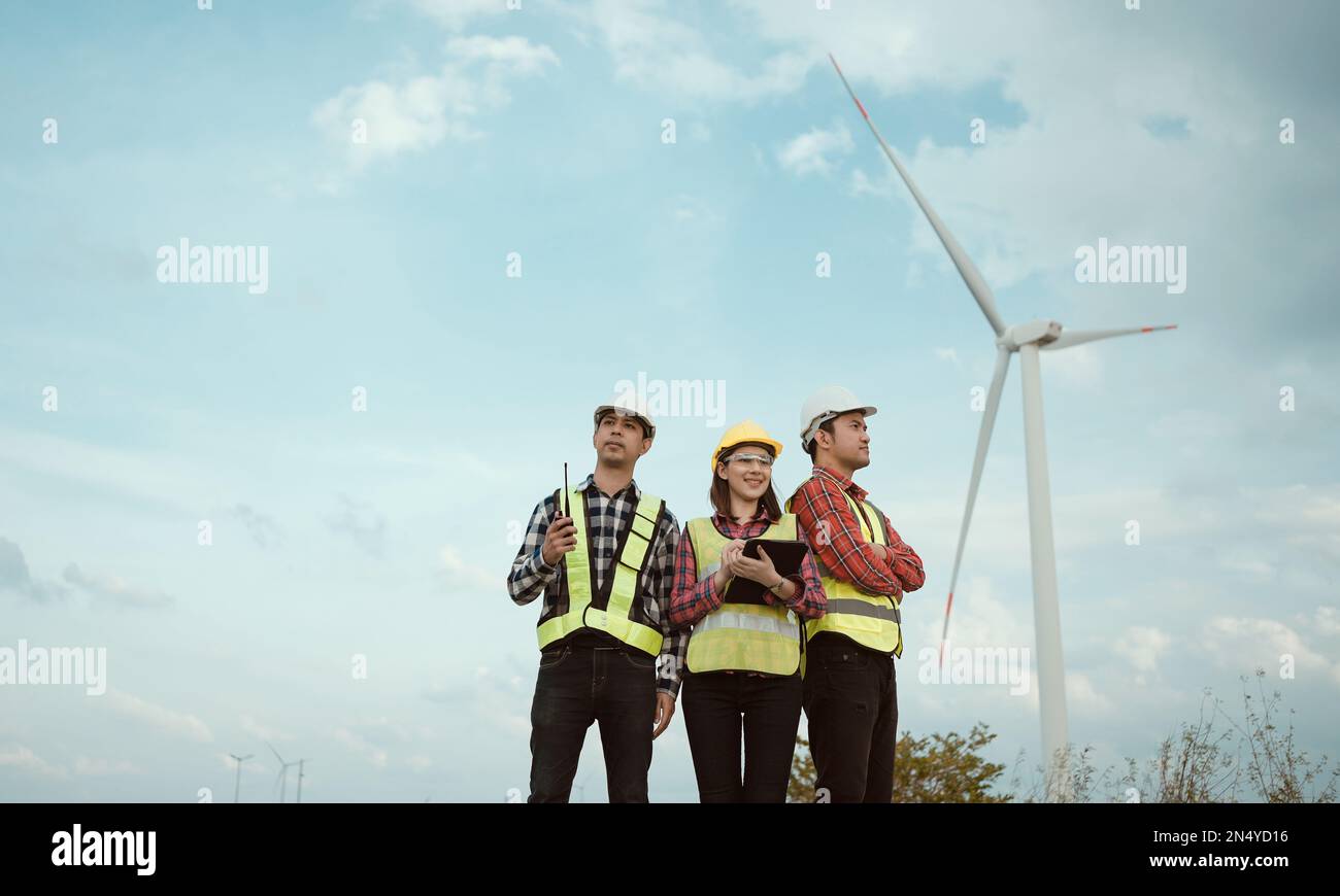 Portrait of a group of happy engineers looking in an agricultural field ...