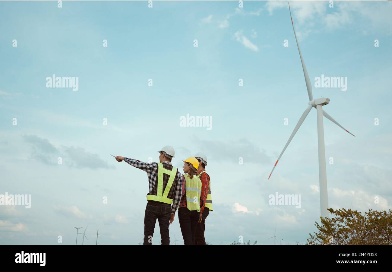 Back view of three engineers discussing and progress check wind turbine ...