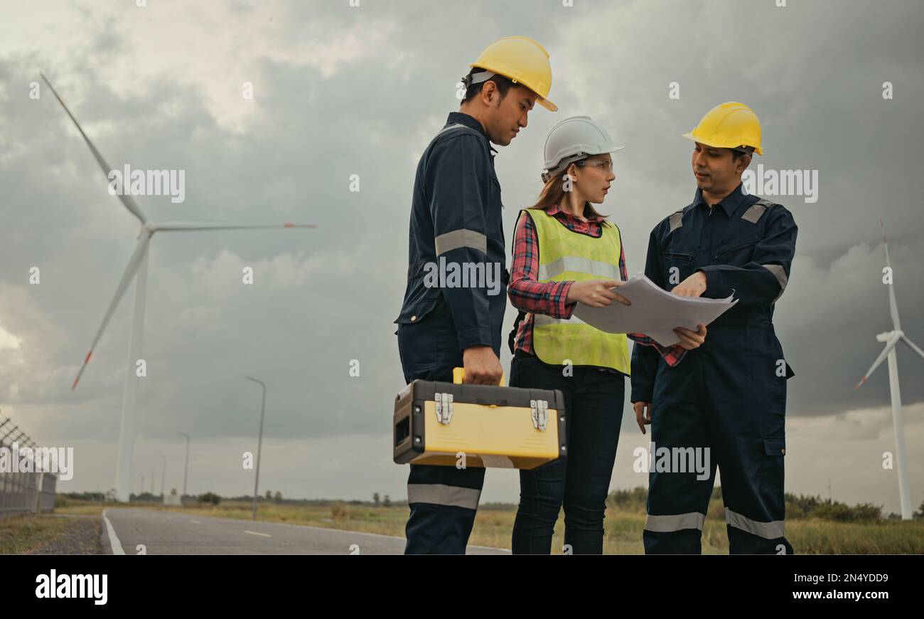 Three technician engineer in uniform with standing and checking wind ...