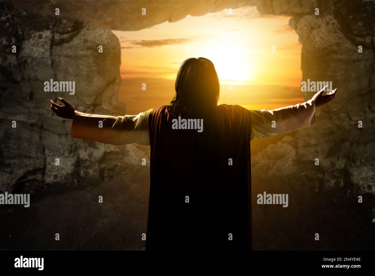 Rear view of Jesus Christ's raised hands and praying to god with a ...