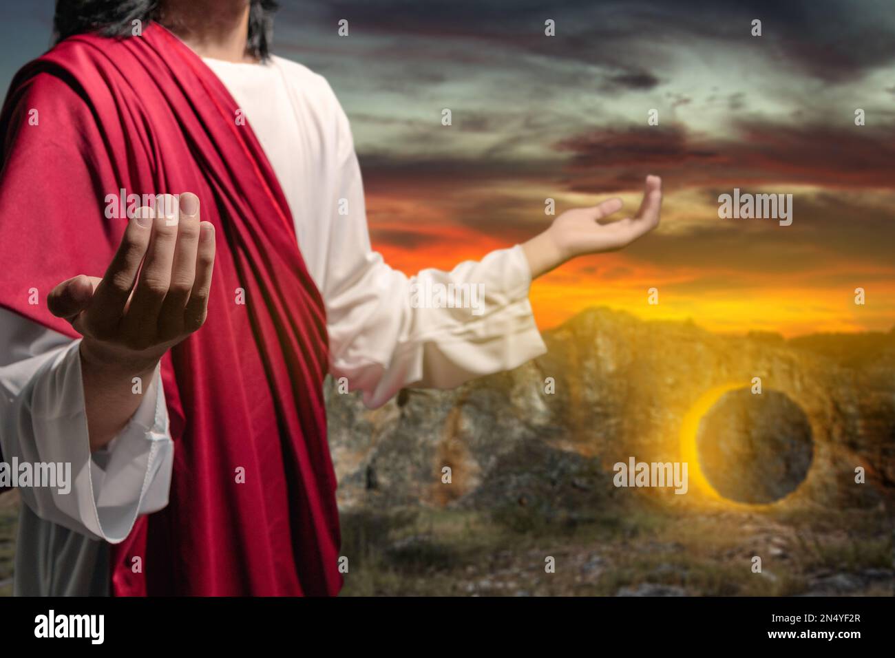 Jesus Christ's raised hands and praying to god with a dramatic sky ...