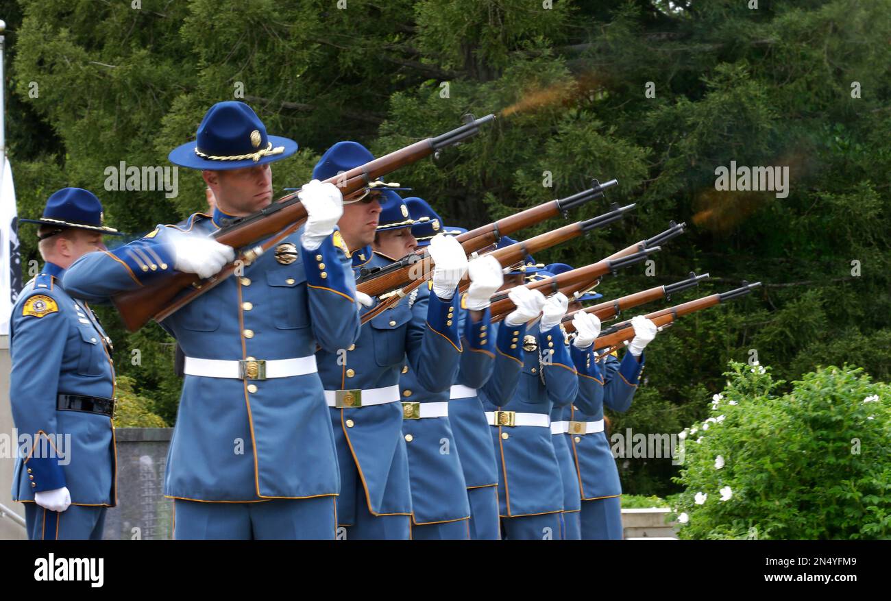 A Washington State Patrol rifle team fires a 21-gun salute during the ...