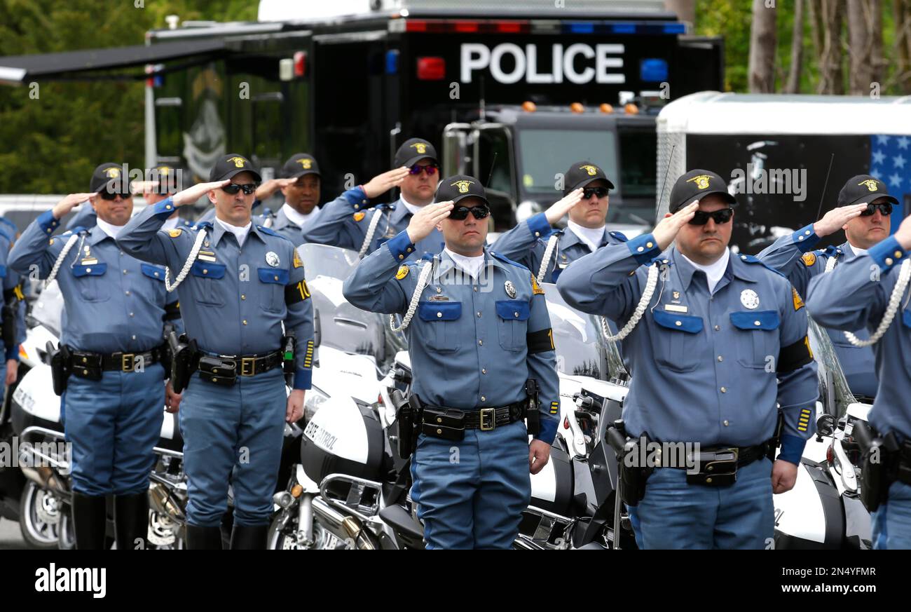 Washington State Patrol troopers stand and salute next to their ...