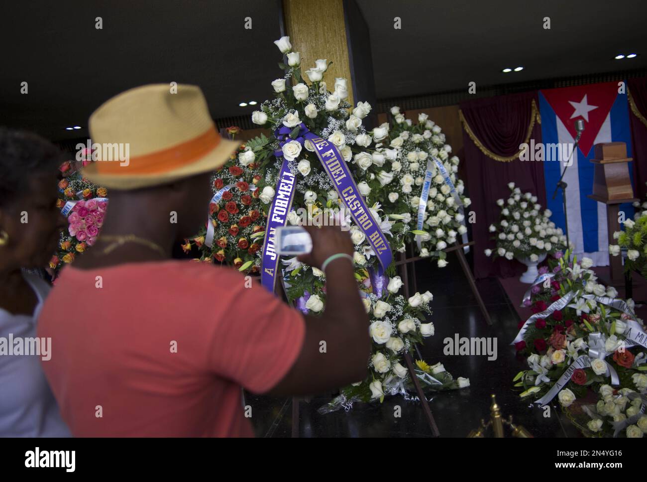 A man takes a picture as he pays his last respects to Cuban musician ...