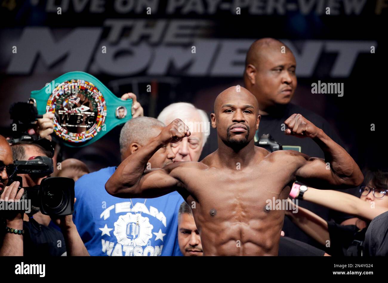 Floyd Mayweather Jr. poses on the scales during the official weigh-in ...