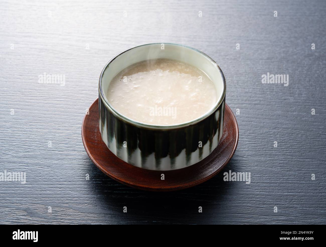 Amazake placed against a black background. Amazake is a traditional ...