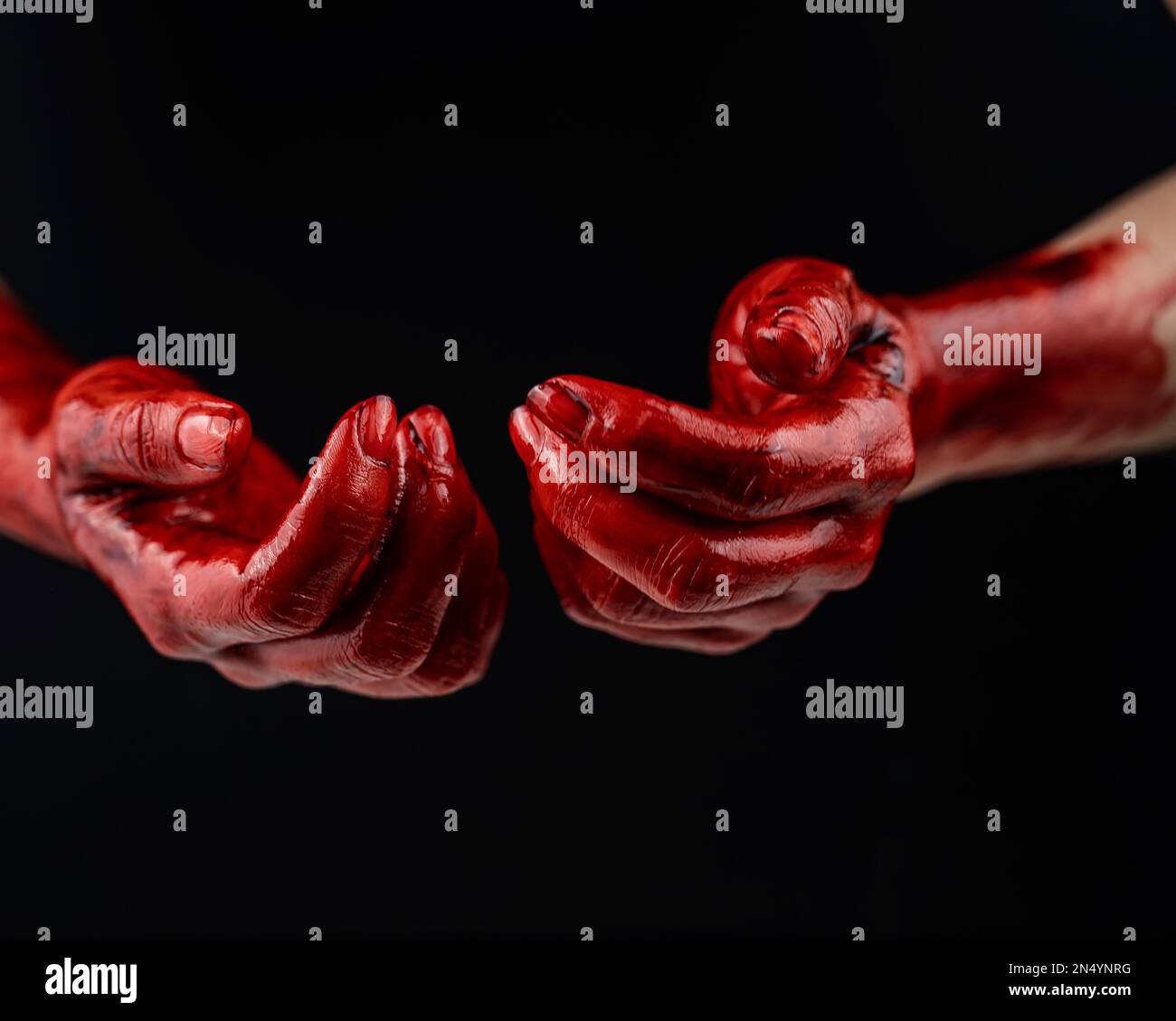 Women's hands in blood on a black background Stock Photo - Alamy
