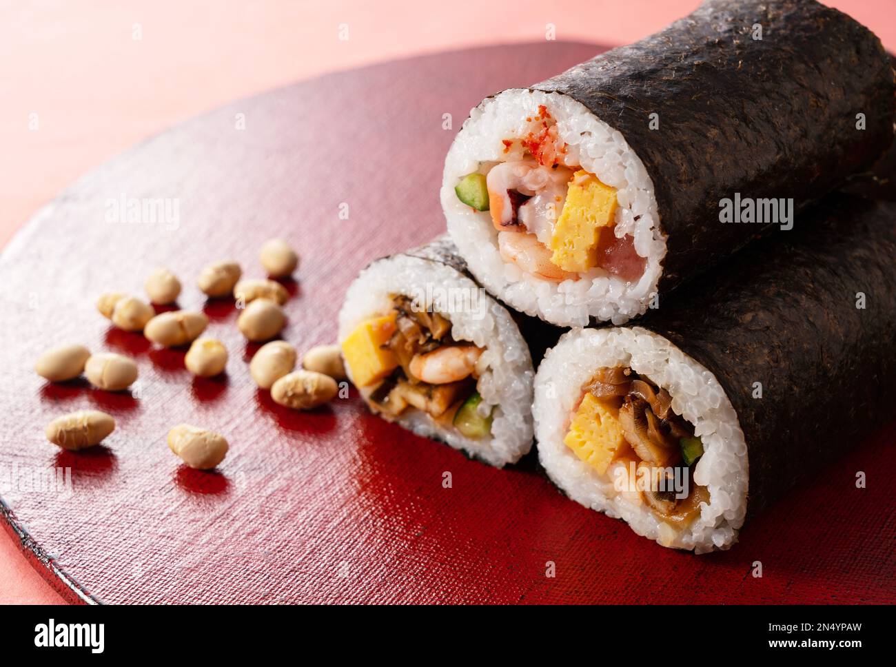 Eho-maki rolls and beans for mame-maki on a red tray. The image of ...