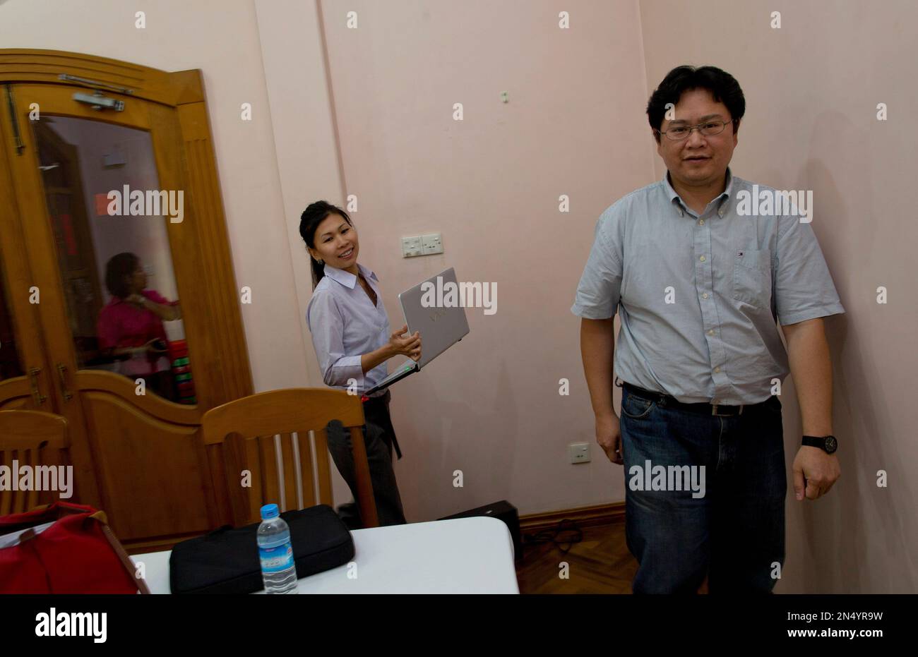 In this March 20, 2013 photo, business partners Michelle Winn, left and Minn Thein walk at their ...