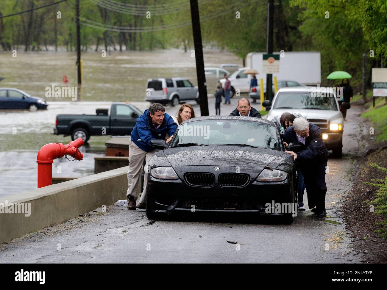Employees from Learn It Systems help push coworker Russell Lum's car to ...