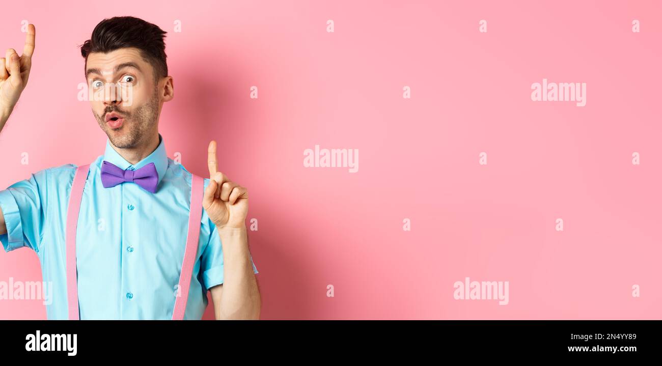 Cheerful funny man dancing in bow-tie and suspenders, pointing fingers ...