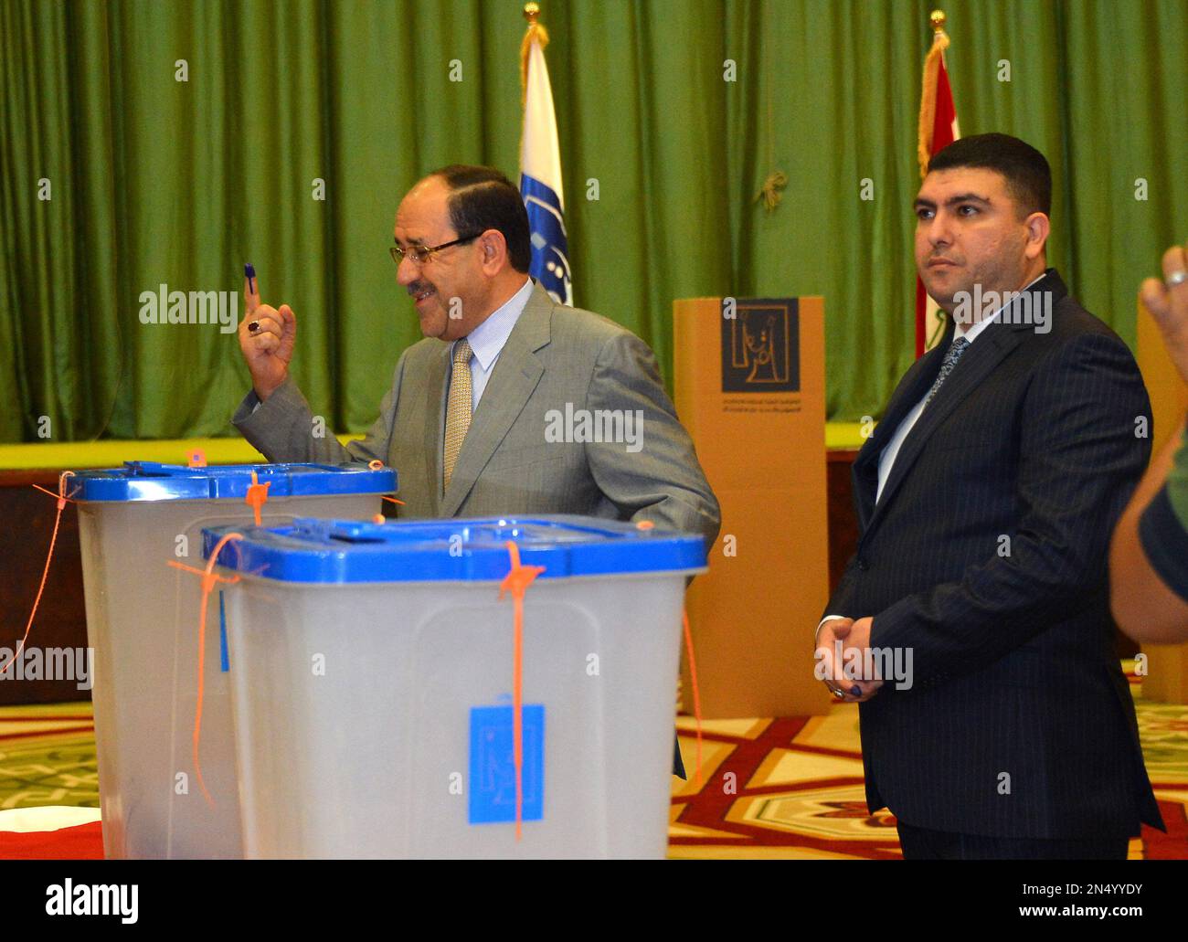 Iraqi Prime Minister Nouri al-Maliki shows his ink-stained finger after ...