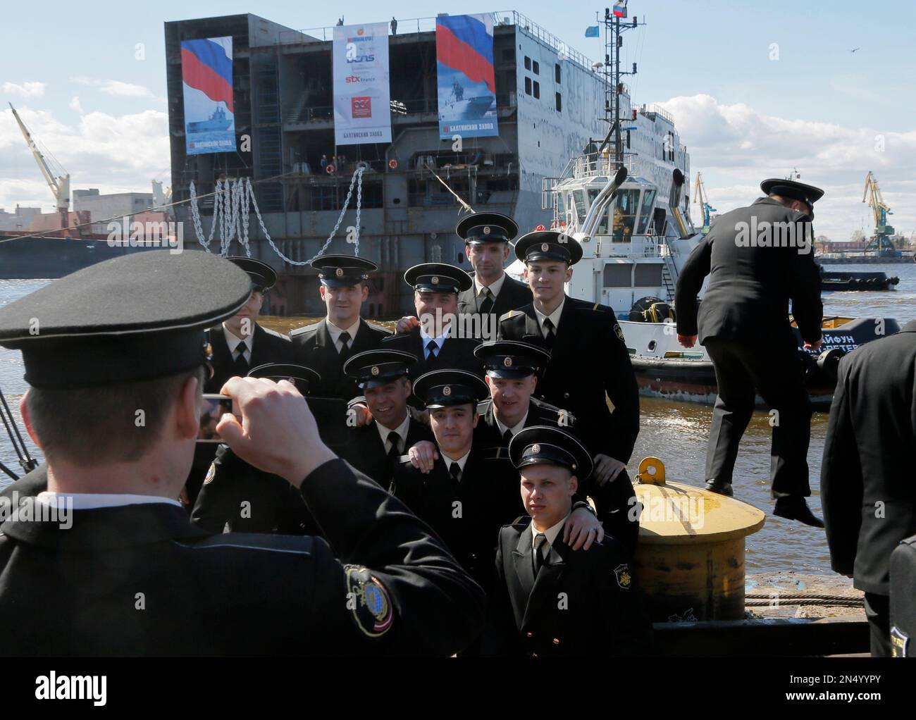 Russian crew members pose fora photo with the stern of Sevastopol, a ...