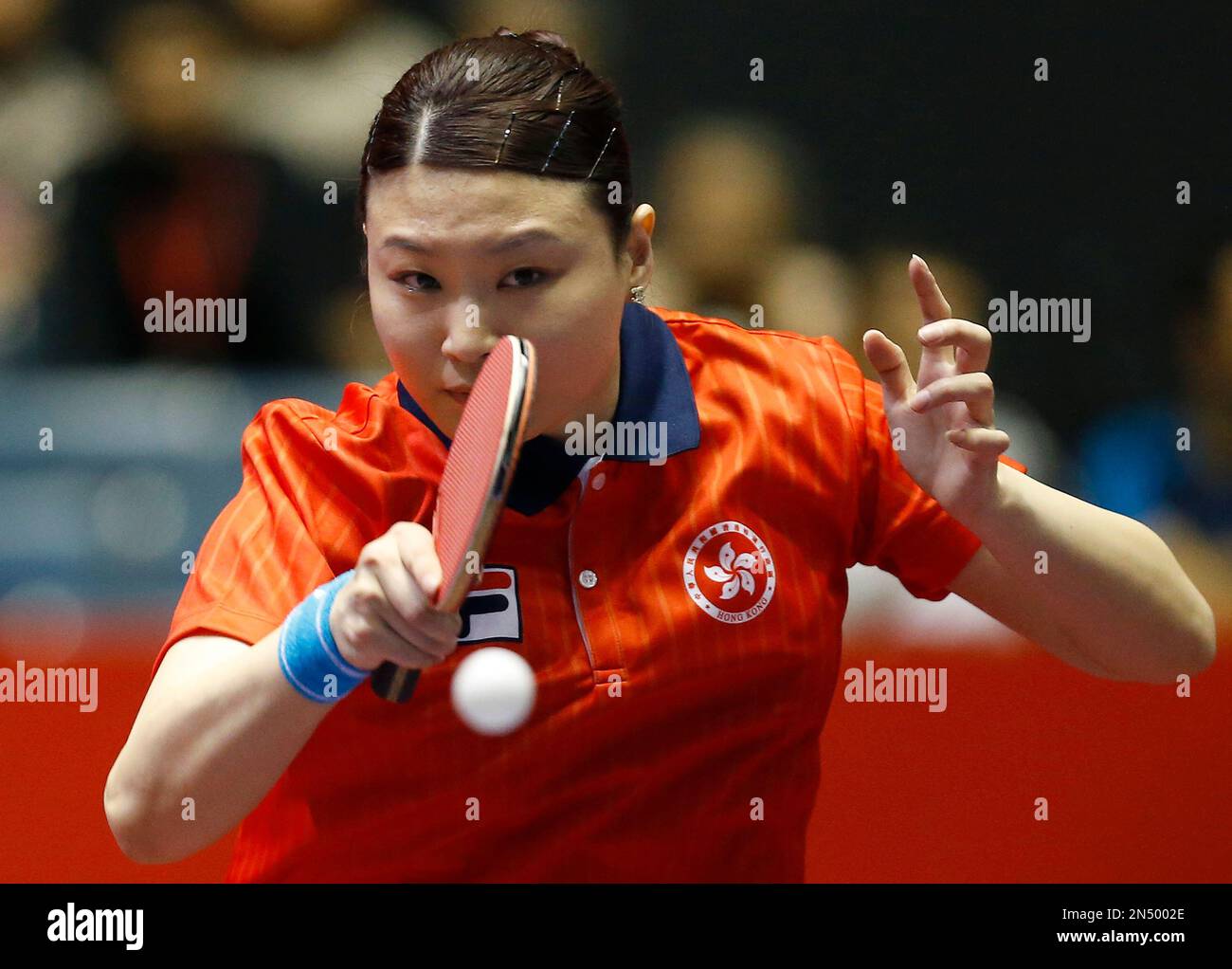 Jiang Huajun of Hong Kong returns a shot to Irene Ivancan of Germany ...