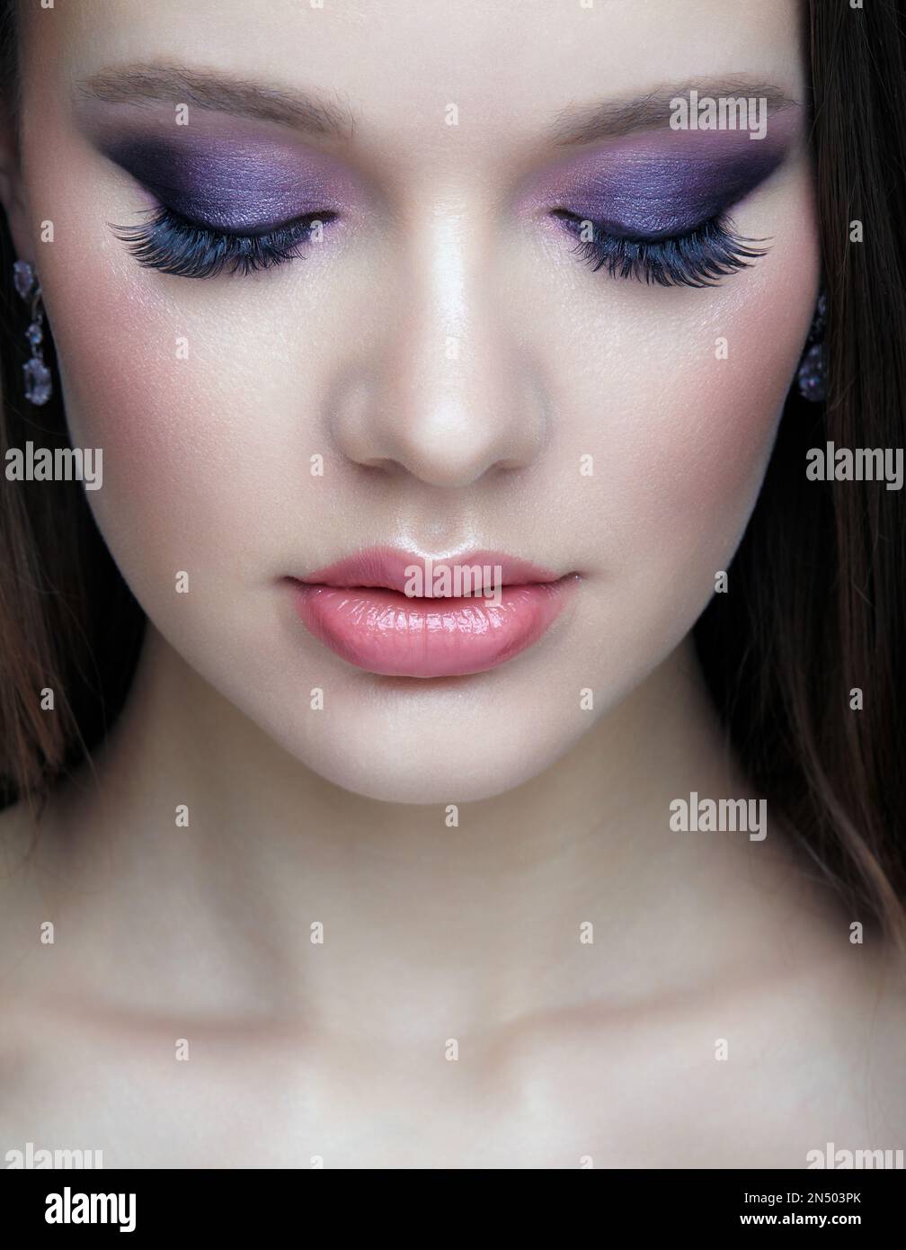 Portrait of young female face. Woman with lilac beauty eyes makeup ...