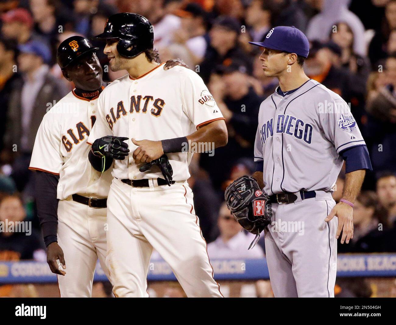 San Francisco Giants' Michael Morse, center, gets a pat on the shoulder ...