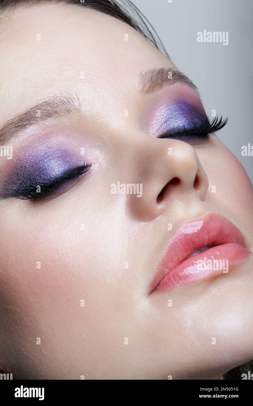 Portrait of young female face with eyes closed. Woman with lilac beauty ...