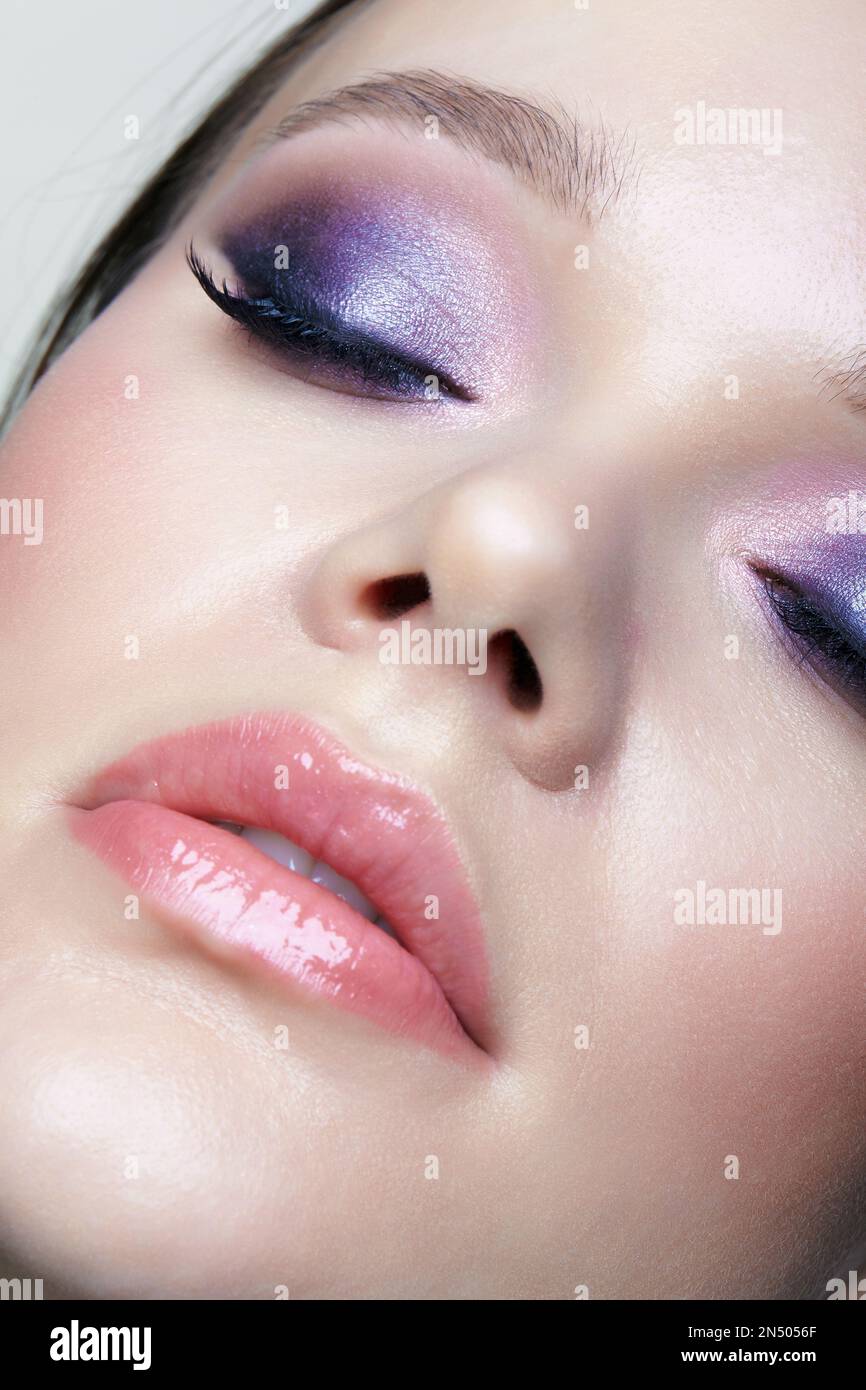 Portrait of young female face with eyes closed. Woman with lilac beauty ...