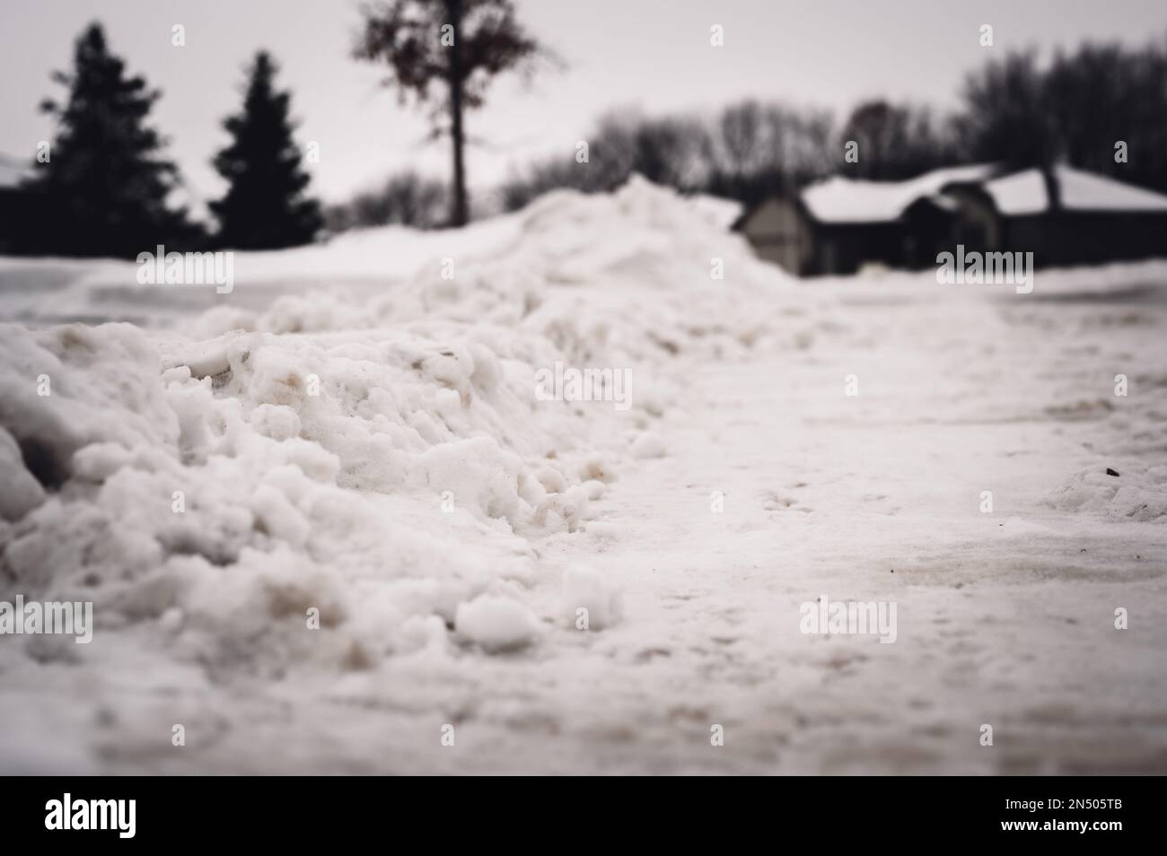 Snowbank at the end of a driveway left after city snowplows cleared a ...