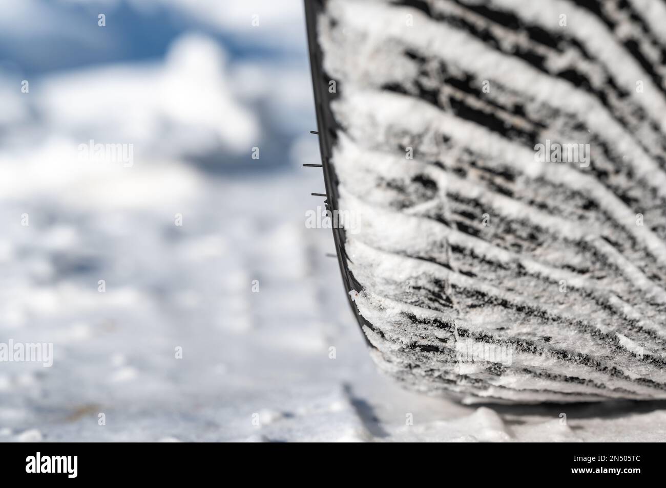 Closeup selective focus on snow packed in an all-weather tire tread ...