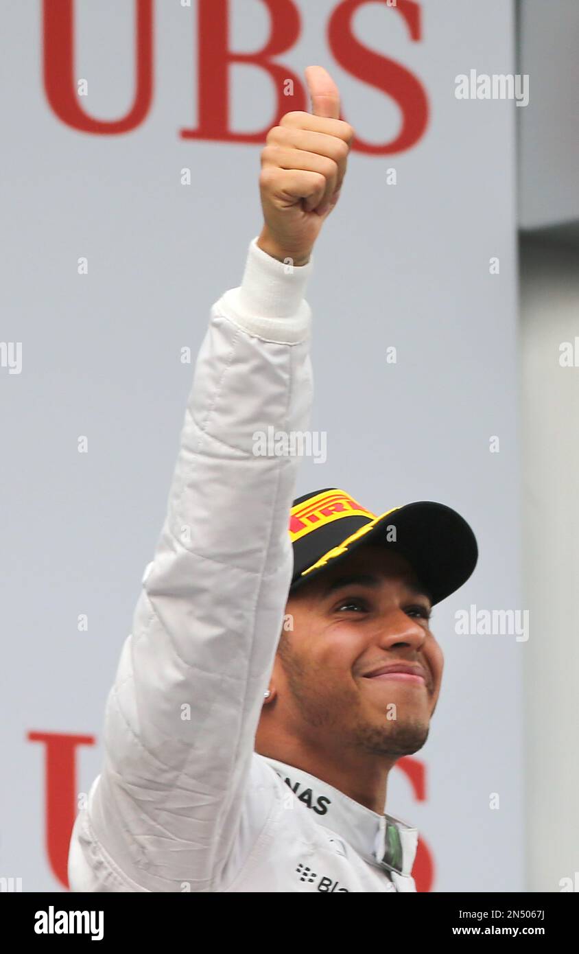 Mercedes driver Lewis Hamilton of Britain gestures during the prize ...