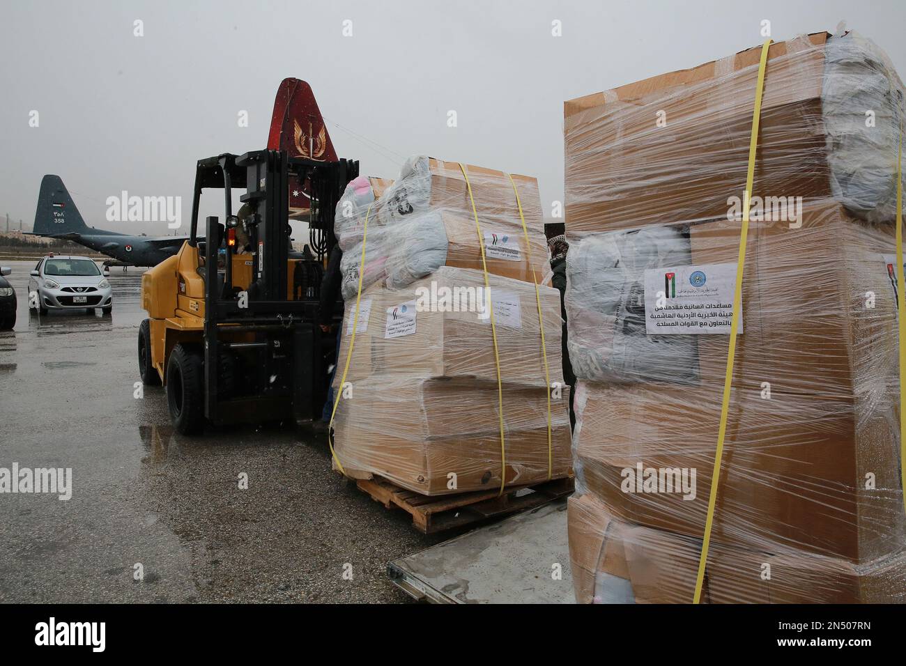 Amman, Jordan. 8th Feb, 2023. Staff members move humanitarian aid at ...