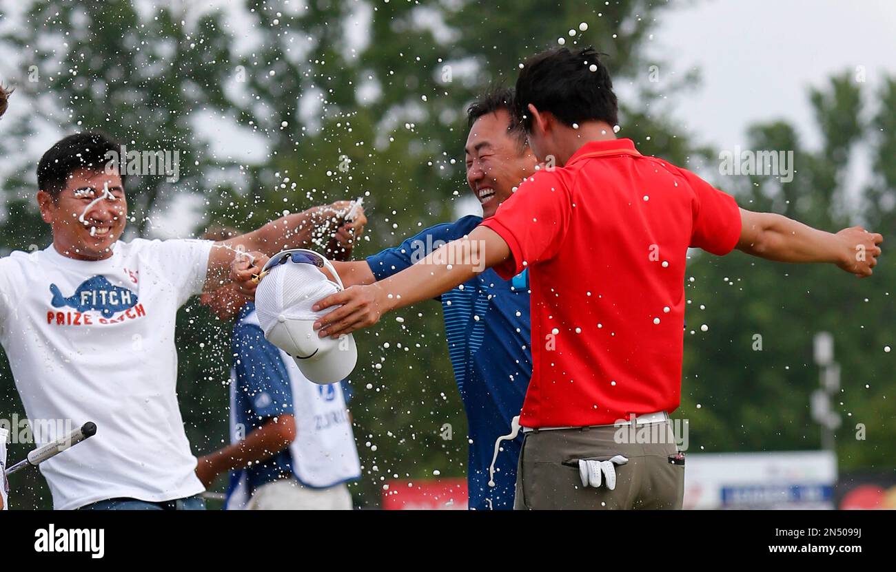 South Korean golfers Y.E. Yang, left, and Charlie Wi, center, douse Noh ...