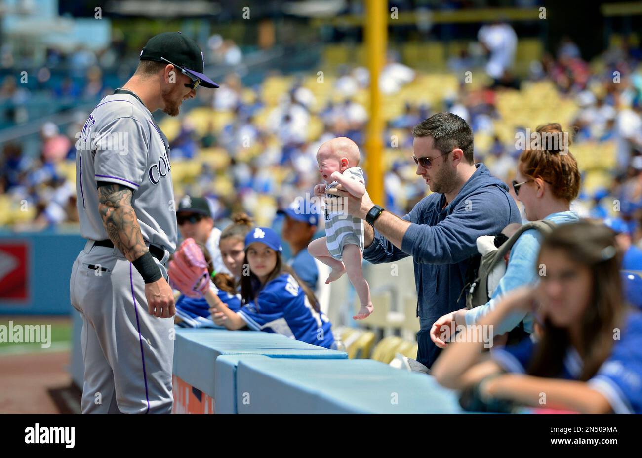 Colorado Rockies' Brandon Barnes, left, greets his nephew Declan Dooley ...