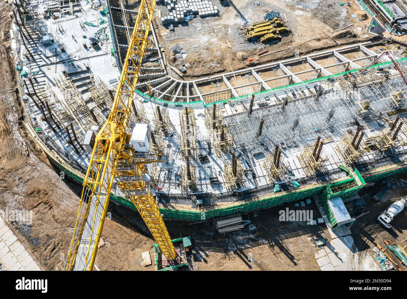 yellow tower crane on big construction site. construction of the ...