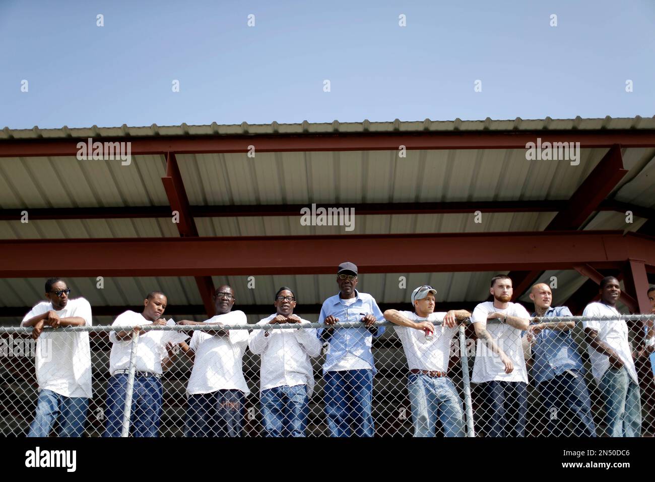 Inmates watch as visitors arrive at the Angola Prison Rodeo in Angola ...