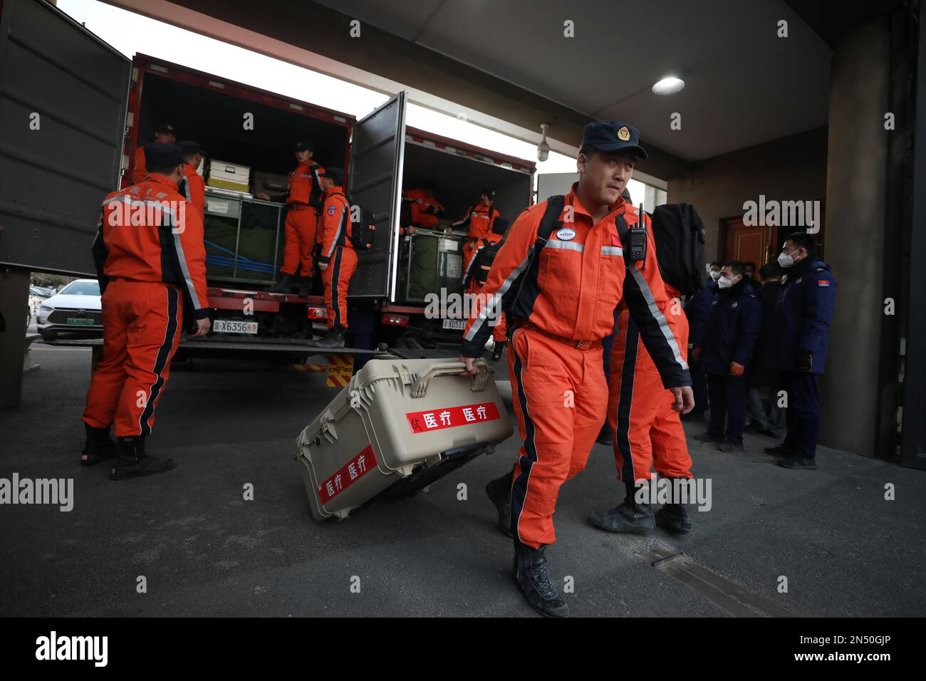 Members of a Chinese rescue team carry equipment and supplies before ...