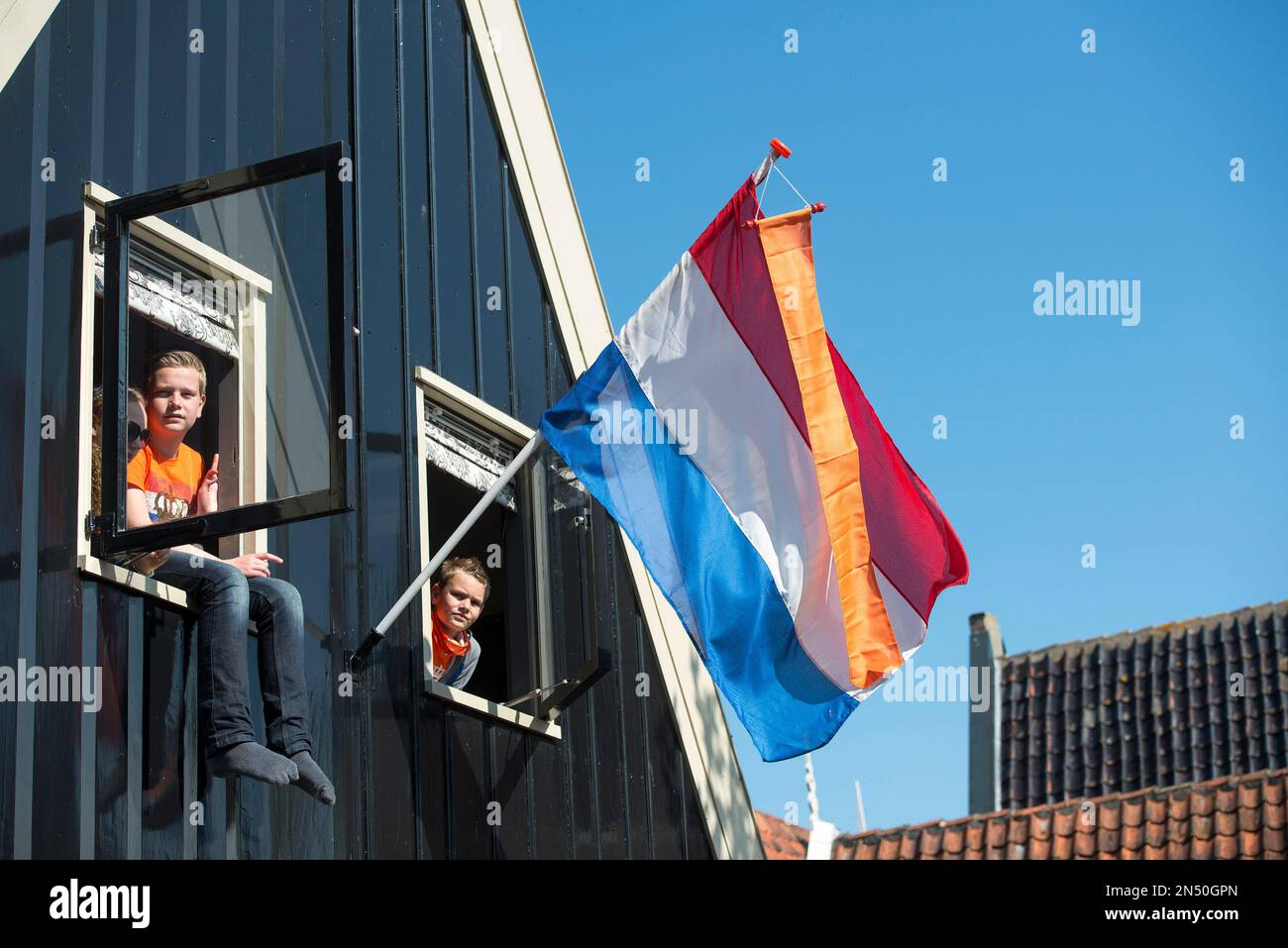 People look out of windows to get a glimpse of Netherlands' King Willem ...