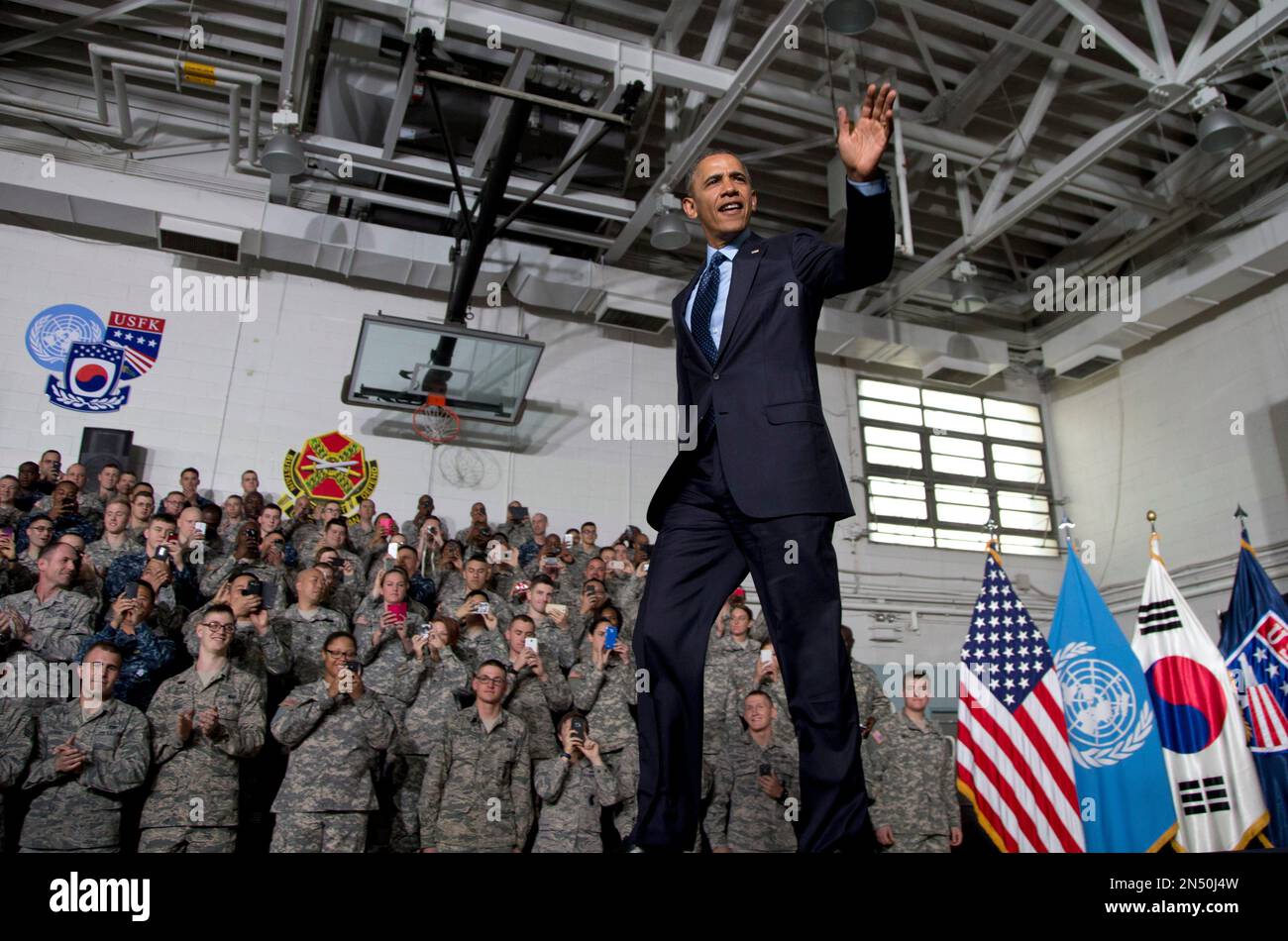 President Barack Obama waves to the cheering crowd as he arrives to ...